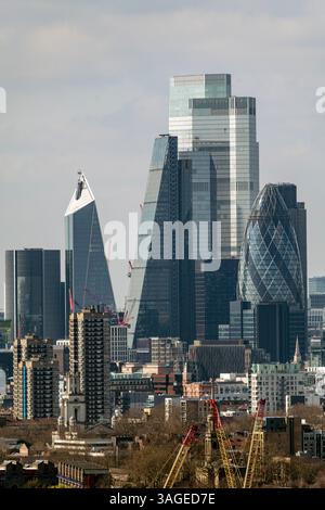 A city skyline with tall skyscrapers seen through a haze in the early ...