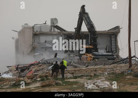 Israeli excavators equipped with breaker tools carry out the demolition ...