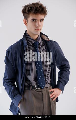 Young man wearing striped navy t-shirt standing over isolated red ...