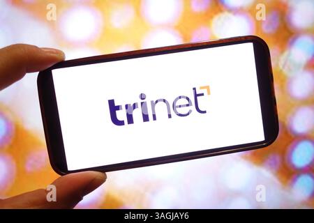 In this photo illustration, the TriNet company logo is seen displayed ...