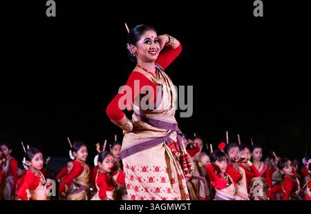 An instructor dance as participants follows the dance step in a Bihu ...