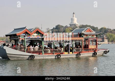 Tourists admire scenery by boats at a park in Beijing, China, 20 July ...
