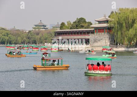 Tourists admire scenery by boats at a park in Beijing, China, 20 July ...