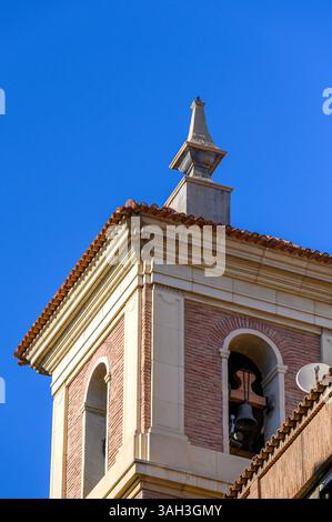 Ancient bell tower of St. Peter’s Church framed by other buildings ...