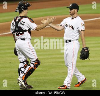 The Miami Marlins shakes hands after defeating the Texas Rangers in a ...