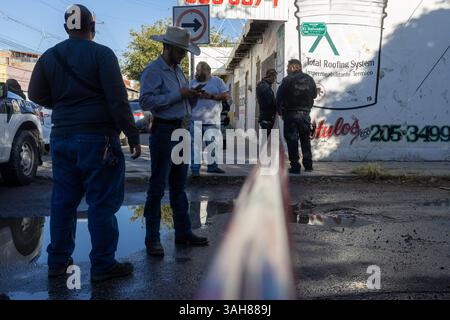 Police and civilians at a crime scene in Ciudad Juarez, marked by ...