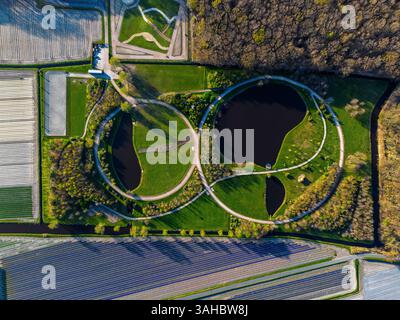 Aerial view of a uniquely designed park with circular paths and ponds ...