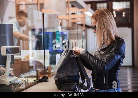 Woman buys a ticket Stock Photo - Alamy