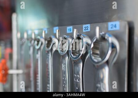 Collection of spanners wrench tools tidy on board in garage Stock Photo ...