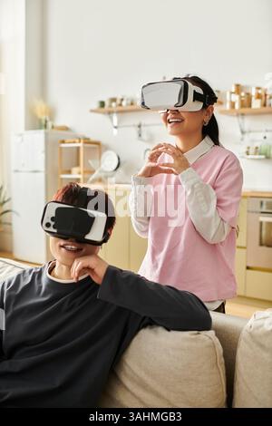 Young woman engages with virtual reality in a cozy bedroom setting ...