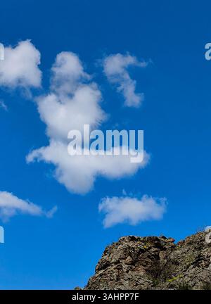 Bright cloud formations drifting in clear sky forming calming ...