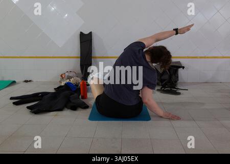 Freediver stretching before competing in a freediving championship ...