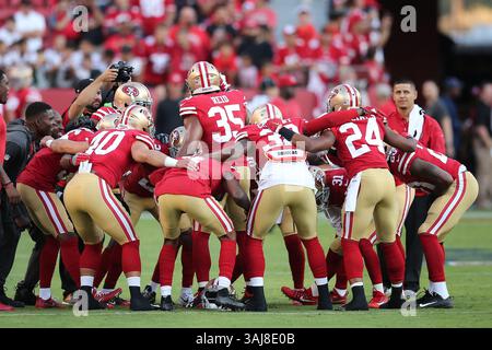 Denver Broncos players huddle before an NFL football game against the ...