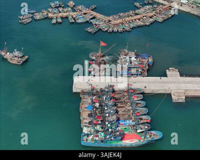 YANTAI, CHINA - APRIL 11, 2025 - Fishing boats take shelter from ...
