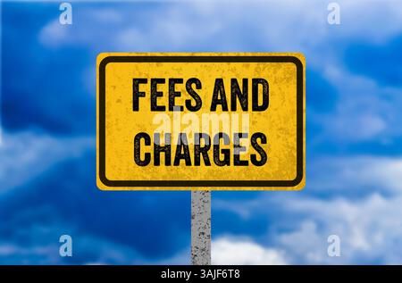 Fees and charges message written on red round sign on blue sky ...