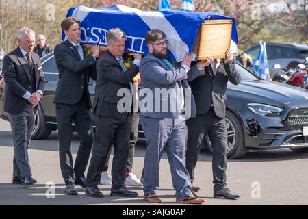 Keith Brown MSP (centre) carries the coffin at the funeral of his ...