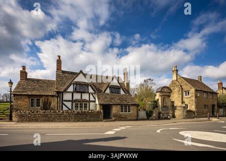 Traditional medieval houses and WW1 memorial in the historic village of ...