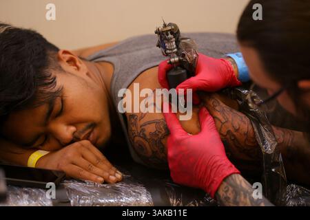 Tattoo artists and enthusiasts get tattooed during the ''Nepal Tattoo ...