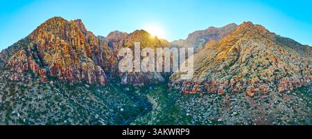 Sunrise over the Grand Canyon with a vivid sky and rugged cliffs in the ...