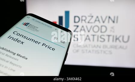 Stuttgart, Germany - 11-22-2024: Person holding smartphone with logo of ...