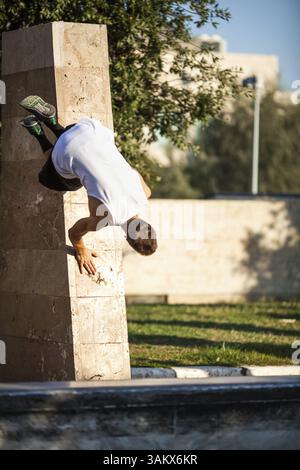 A free running athlete shows his parkour skills during the Skyladder ...