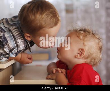 Two little brothers are kissing. Close up portrait. Cute siblings Stock Photo - Alamy