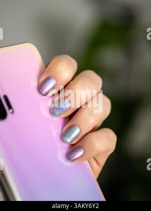 Female hand with pink nail design with gold foil Stock Photo - Alamy