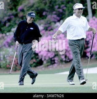 Phil Mickelson, left, and Fred Couples wait to putt at the third green ...