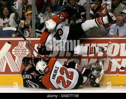 Philadelphia Flyers' Mike Knuble takes a spill on the ice as he battles for the puck against ...