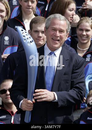 President George W. Bush is presented an Olympic Torch by Paralympics ...