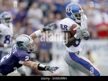 Kansas' Dexton Fields catches a pass in front of Kansas State's Marcus ...