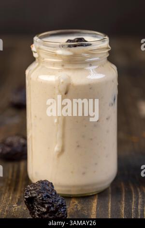 yogurt with prune flavor with dried plum , glass jar with natural prune ...