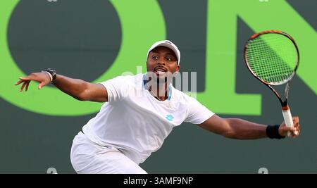 John Isner returns against Donald Young during the second round of the ...