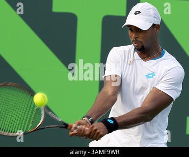 John Isner returns against Donald Young during the second round of the ...
