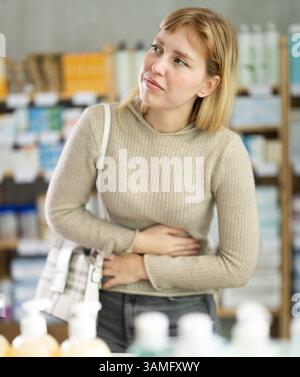 Young blonde woman holding menstrual cup screaming proud, celebrating ...