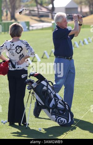 President Bill Clinton and his cousin, Lisa Cornwell, sit in a golf ...