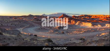 The Henry Mountains rise above the colorful Bentonite Hills during a ...