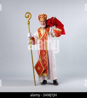 Saint Nicholas with sack on light grey background Stock Photo - Alamy