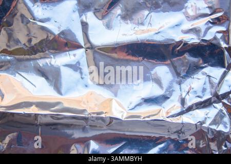 Crumpled reflective shiny gift wrapping material texture background ...