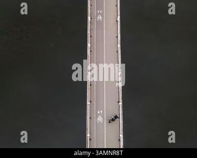 Aerial view of baltasis tiltas bridge over neris river with modern city ...