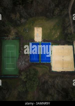 An aerial view of sports complex featuring tennis courts and swimming ...