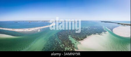 Aerial view of colorful boats and sandbanks in Hurricane Pass with a ...
