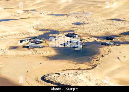 Aerial view of beached houses with flood on Stockton Beach, Worimi ...