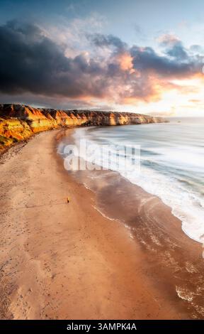 Aerial view of Maslin Beach with cliffs and a dramatic sunset over the ...