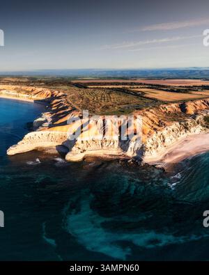 Aerial view of Port Willunga beach with caves in the cliff wall and ...