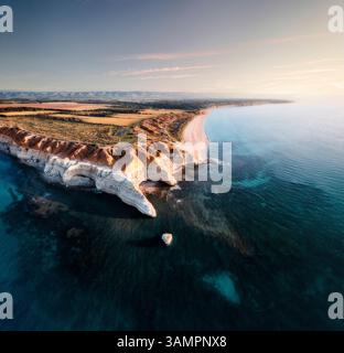 Aerial view of Port Willunga beach with caves in the cliff wall and ...