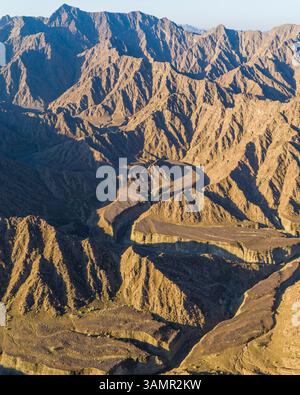Aerial view of a canyon among the rocky and dry mountains in the desert ...