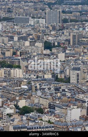 Aerial view of dense metropolis with modern skyscrapers and cloudy sky ...