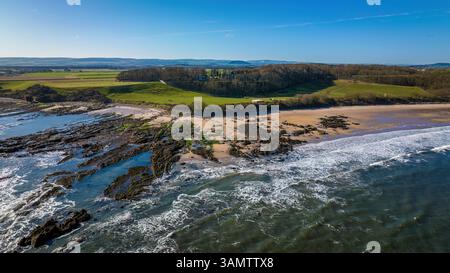 Aerial view of Seacliff Beach with waves and rocky cliffs, North ...