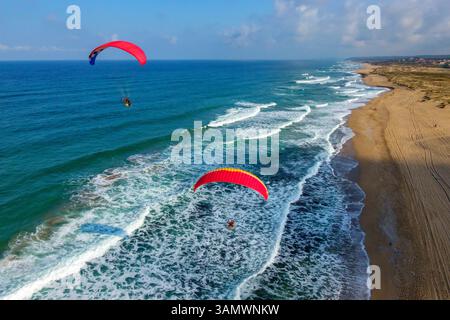 Aerial view of paramotor pilots flying along the Black Sea coast in Sahilkoy, Istanbul, Turkey ...